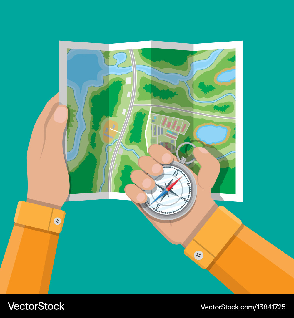 Folded paper city map and compass in hands Vector Image