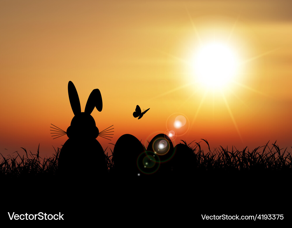 Easter bunny sat in grass against a sunset sky Vector Image