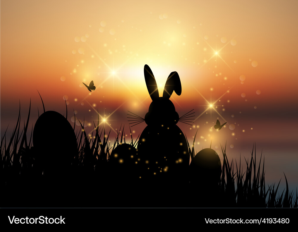 Easter bunny sat in grass against a sunset sky Vector Image