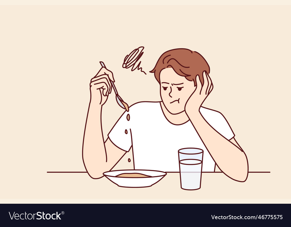 Man suffers from lack of appetite sitting at table Man suffers from lack of appetite sitting at table
