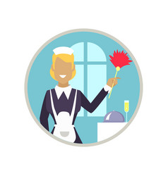 Maid cleaning hotel room with housekeeping trolley