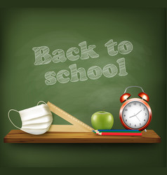Blackboard with school supplies on wooden Vector Image