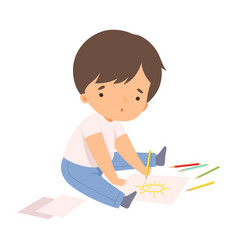 Cute boy sitting on floor and drawing sun with Vector Image